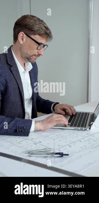 Young professional male architect or engineer focused on a computer ...