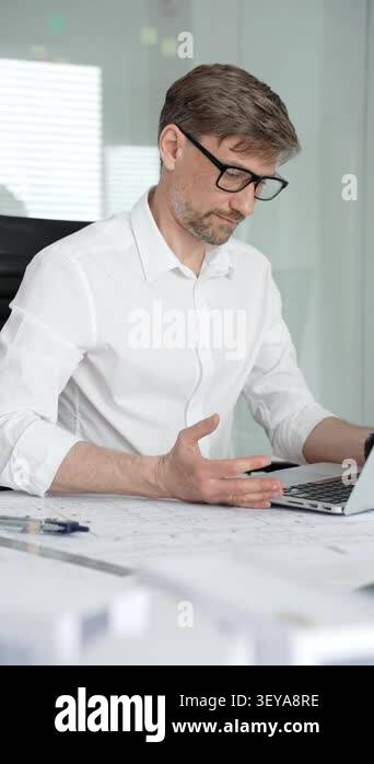Young professional male architect or engineer focused on a computer ...