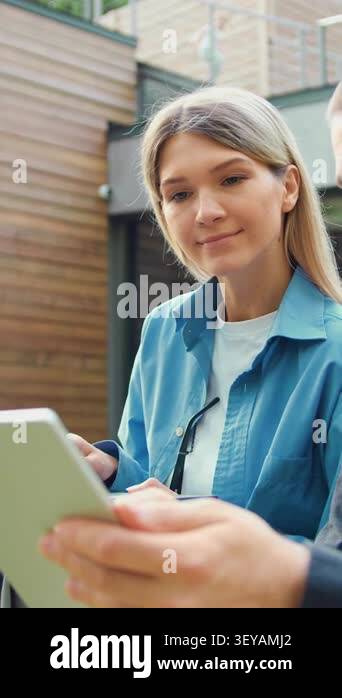 Portrait of student man showing data on a digital tablet while ...