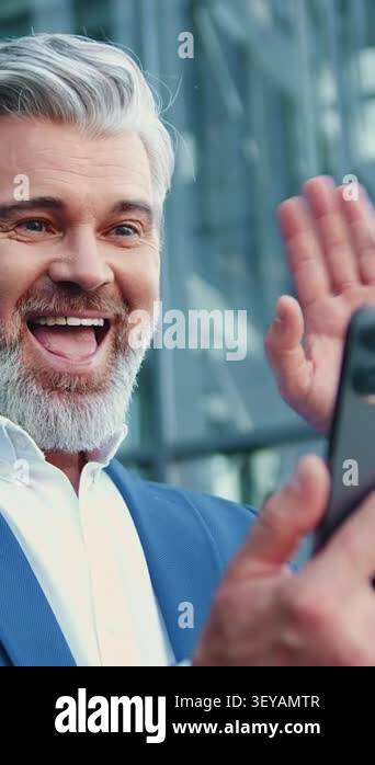 Portrait of smiling old man using digital laptop looking at screen of ...