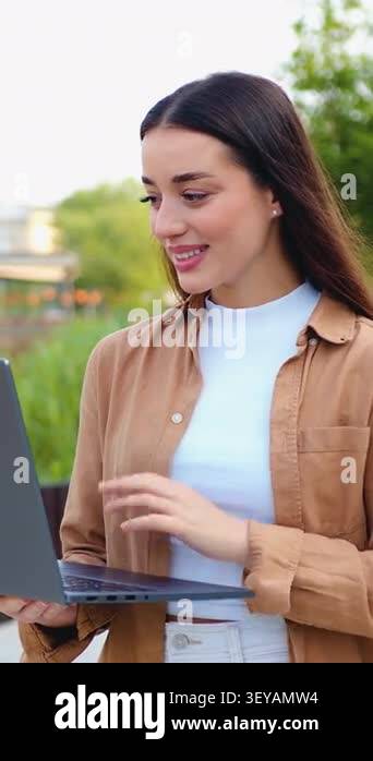 Woman using laptop for video chat, waving hand, friendly conversation ...