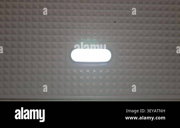 Close up view of a glowing bright white oval LED lamp illumination ...