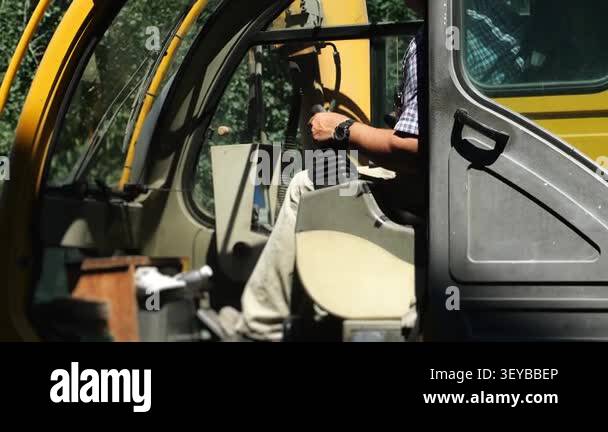 Professional crane operator controls a mobile crane from the cabin ...
