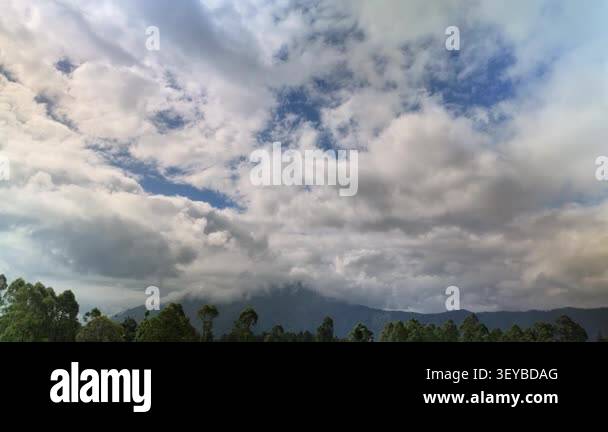 Dramatic time-lapse of thick white clouds moving rapidly over a ...