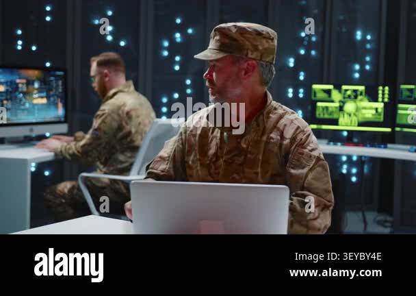 Couple of soldiers collaborating in cyberspace data center office ...