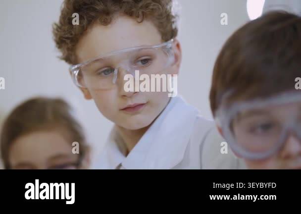 Children in lab coats and goggles eagerly engage in a fun science ...