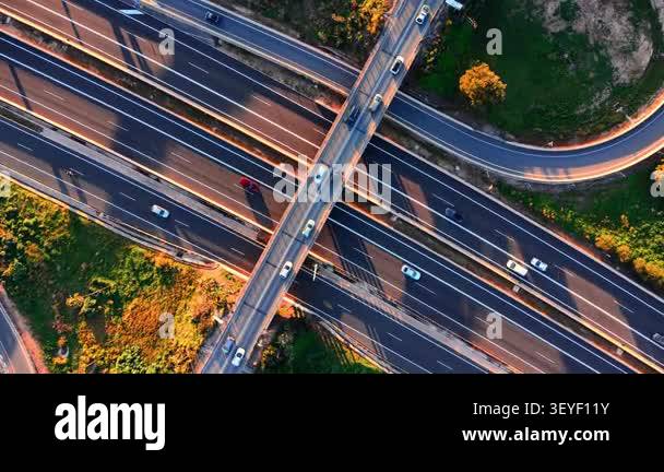 Highway intersection with crossing overpass and car, Spain. Aerial top ...