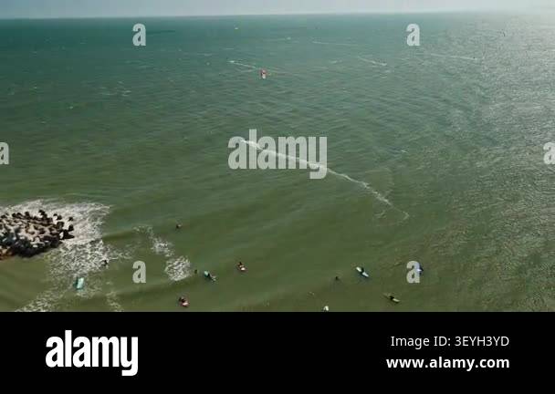 Aerial shot showing multiple kitesurfers riding waves in Mui Ne Stock ...