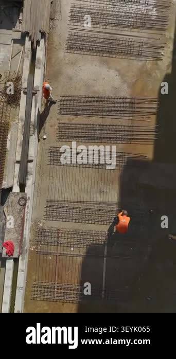 Drone captures organized rebar grid and active work process Stock Video ...