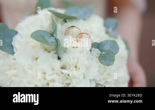 A bride with a wedding ring on her hand strokes and admires her wedding ...