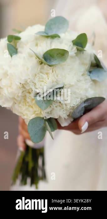 A bride with a wedding ring on her hand strokes and admires her wedding ...