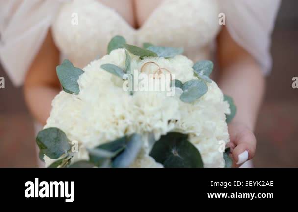A bride with a wedding ring on her hand strokes and admires her wedding ...