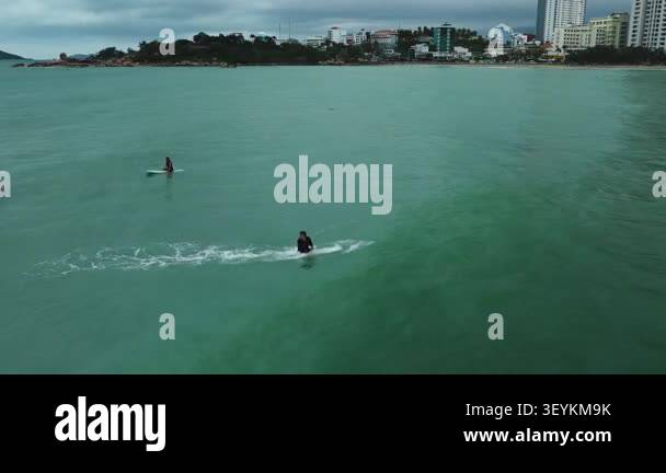 Aerial shot of a minimal surf scene with few people in Vietnam ocean ...