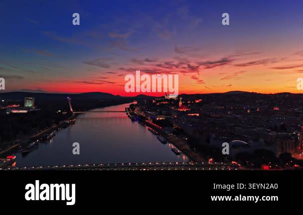 A view of the Danube River in Bratislava during sunset. The sky shows ...