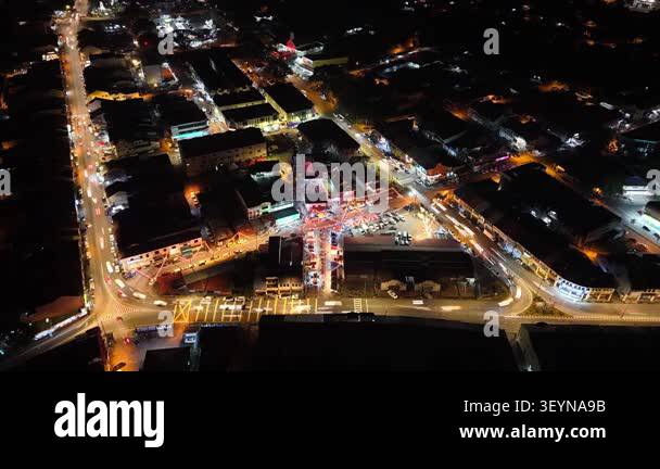 Aerial night footage showing traffic light trails and illuminated ...