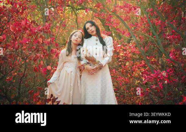 Two fantasy women walking in forest, young mother and adult daughter ...