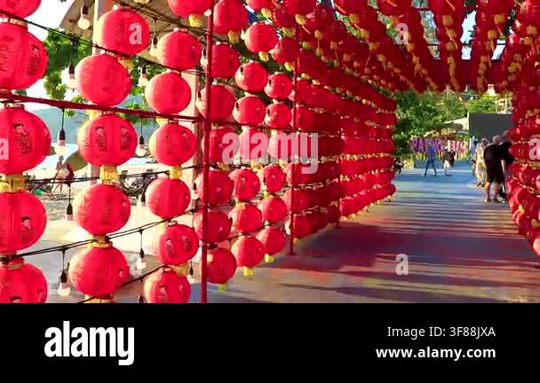 Tunnel made of Chinese red lanterns during a festive beach celebration ...