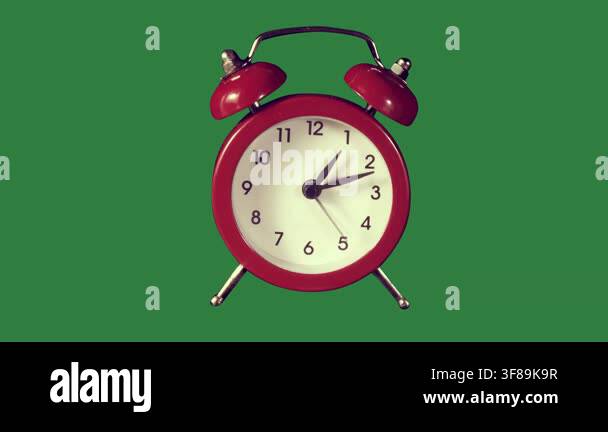alarm clock on a green background Stock Video Footage - Alamy