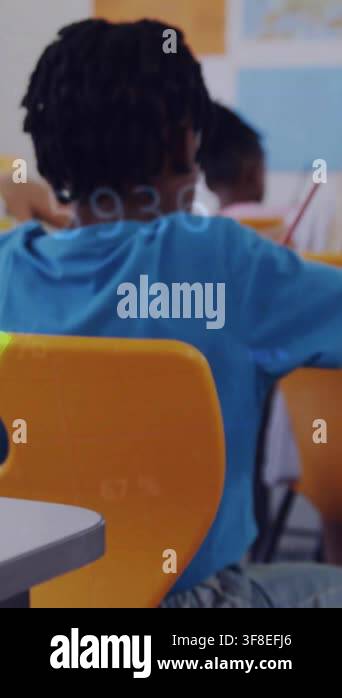 Vertical video: Student in blue tee writing camera panning driving neon ...