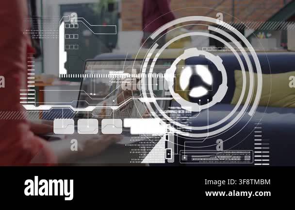 Seated woman typing on laptop initiating HUD animation for tech UI ...