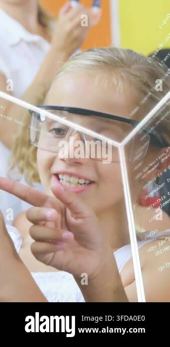 Vertical video: Student with goggles in classroom, hologram cube ...