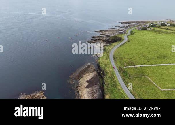 Aerial view flying forward along Mullaghmore Head coast, capturing sea ...