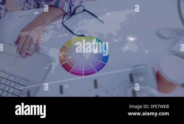 Designer using laptop touchpad, camera pulling back, moving charts over ...