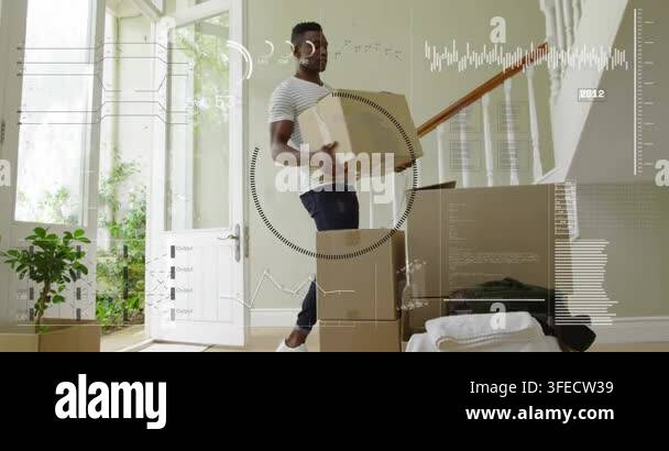 Man carrying moving box entering foyer and placing box on stack while ...