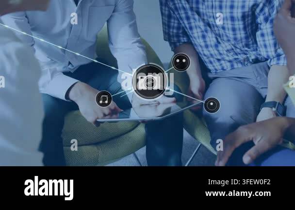 White Shirted Man Tapping Tablet Team Leaning Camera And Music Icons