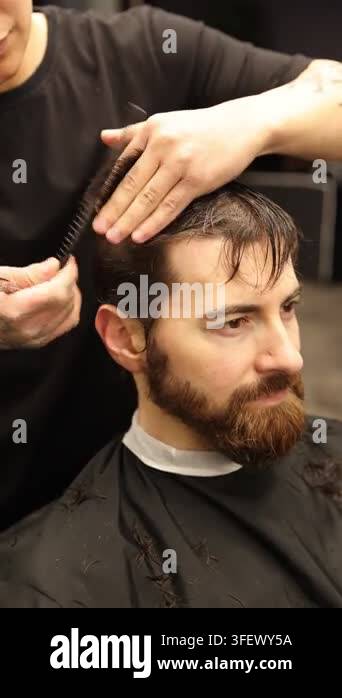 Barber cutting man's hair with scissors in salon, closeup Stock Video ...