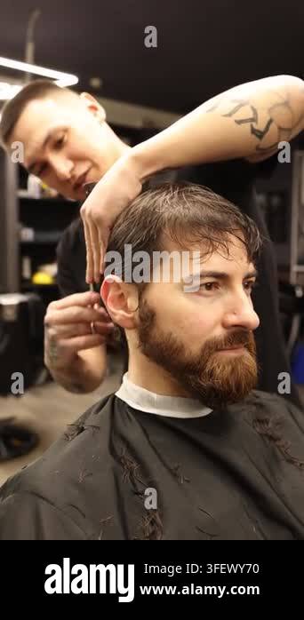 Barber cutting man's hair with scissors in salon Stock Video Footage ...