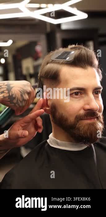 Barber cutting man's hair with clipper in salon, closeup Stock Video ...