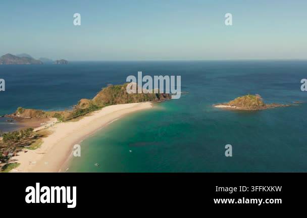 Aerial view of tropical island with sandy beach. Nacpan, El Nido ...