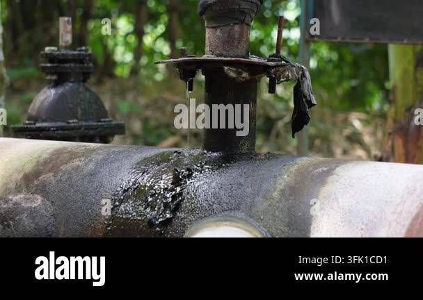 Crude oil leak from industrial wellhead equipment Stock Video Footage ...