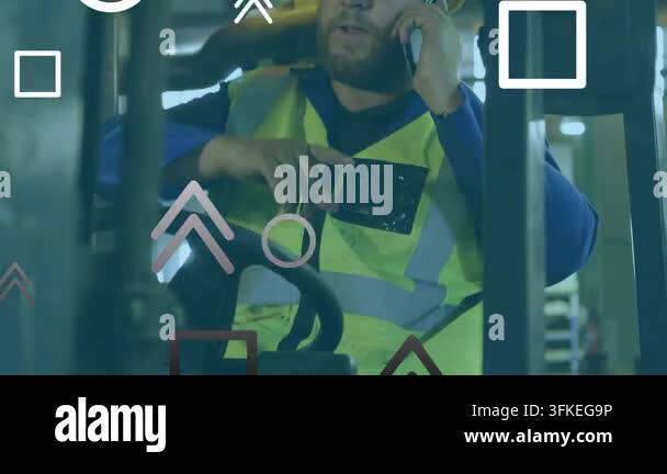 Forklift operator answering call then checking phone in warehouse ...