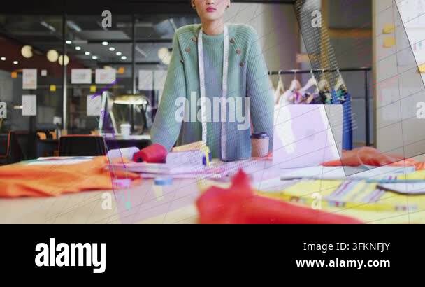 Camera rising, woman fashion designer leaning on table, reviewing ...
