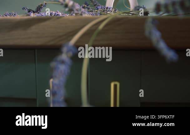 Lavender flowers and oil burner on home green cabinet medium tilting ...