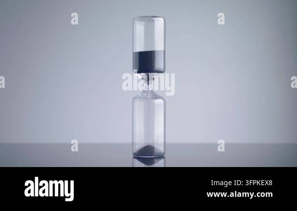 Transparent hourglass filled with black sand Stock Video Footage - Alamy