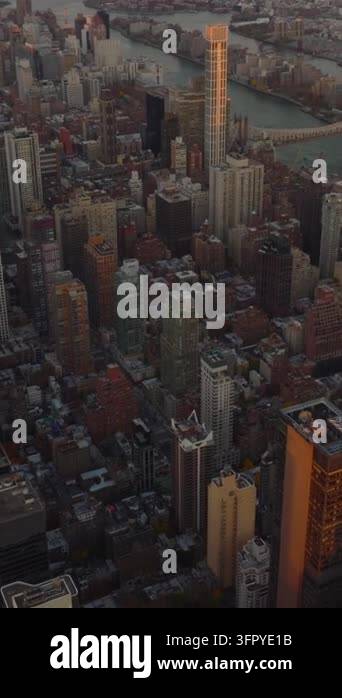 Vertical video: High angle view of high rise buildings built in blocks ...