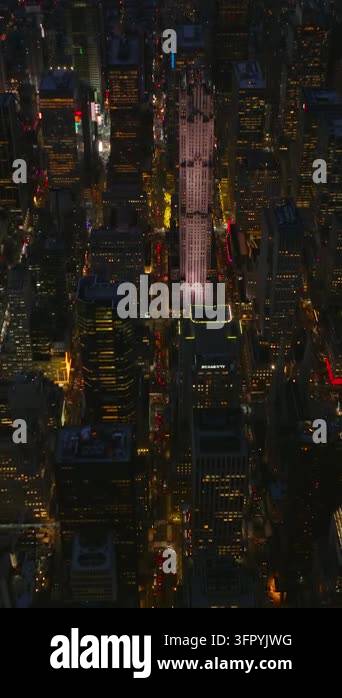 Vertical video: High angle view of high rise buildings in evening town ...