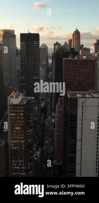 Vertical video: Fly between high rise apartment or office buildings in ...