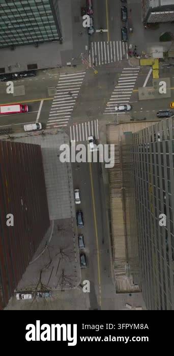 Vertical video: Top down panning footage of high rise buildings and ...