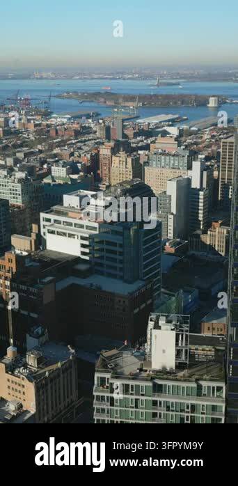 Vertical video: High rise buildings high above other town development ...