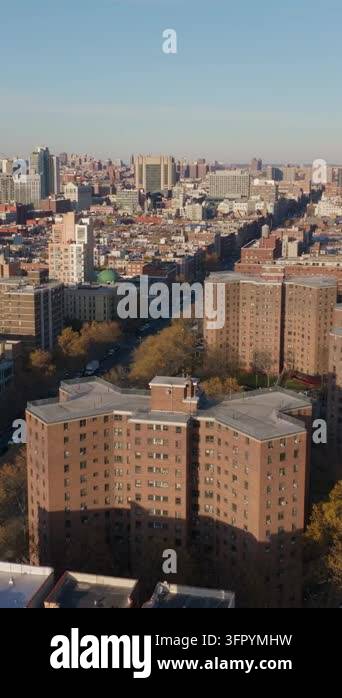 Vertical video: Panning aerial view of a multiple high rise apartment ...