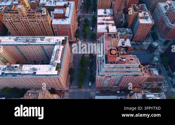 Flying over the street of a modern city along the high-rise buildings ...
