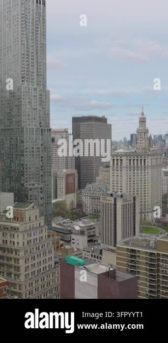 Vertical video: Fly above city. Elevated footage of high rise buildings ...