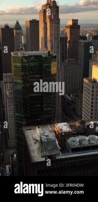 Vertical video: Aerial view of high rise buildings in city. Tilt down ...