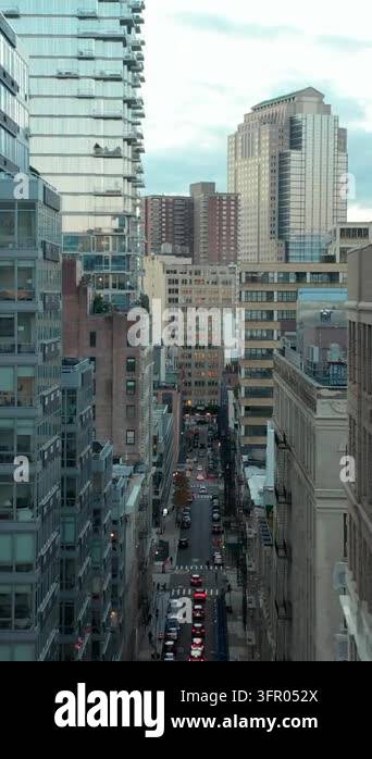 Vertical video: Forwards fly above Civic Centre buildings with flags on ...