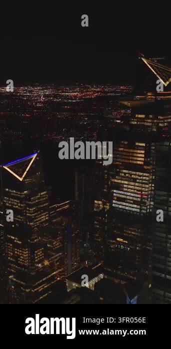 Vertical video: Group of illuminated high rise buildings on Hudson ...