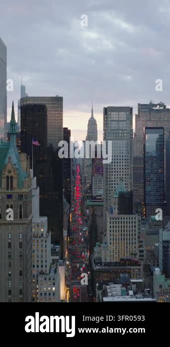 Vertical video: Elevated view of long straight 5th avenue. Commercial ...